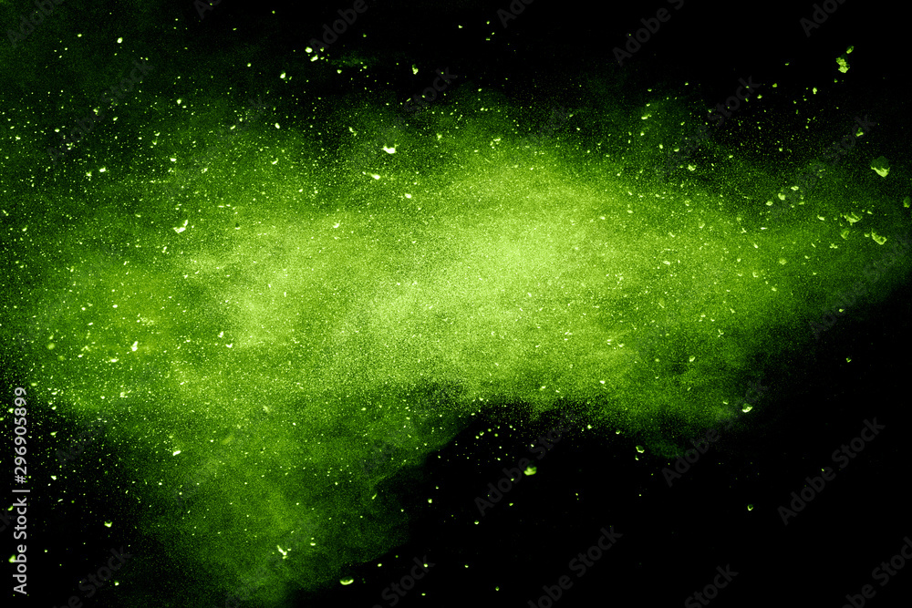Green powder explosion on black background.Green dust particles splash ...