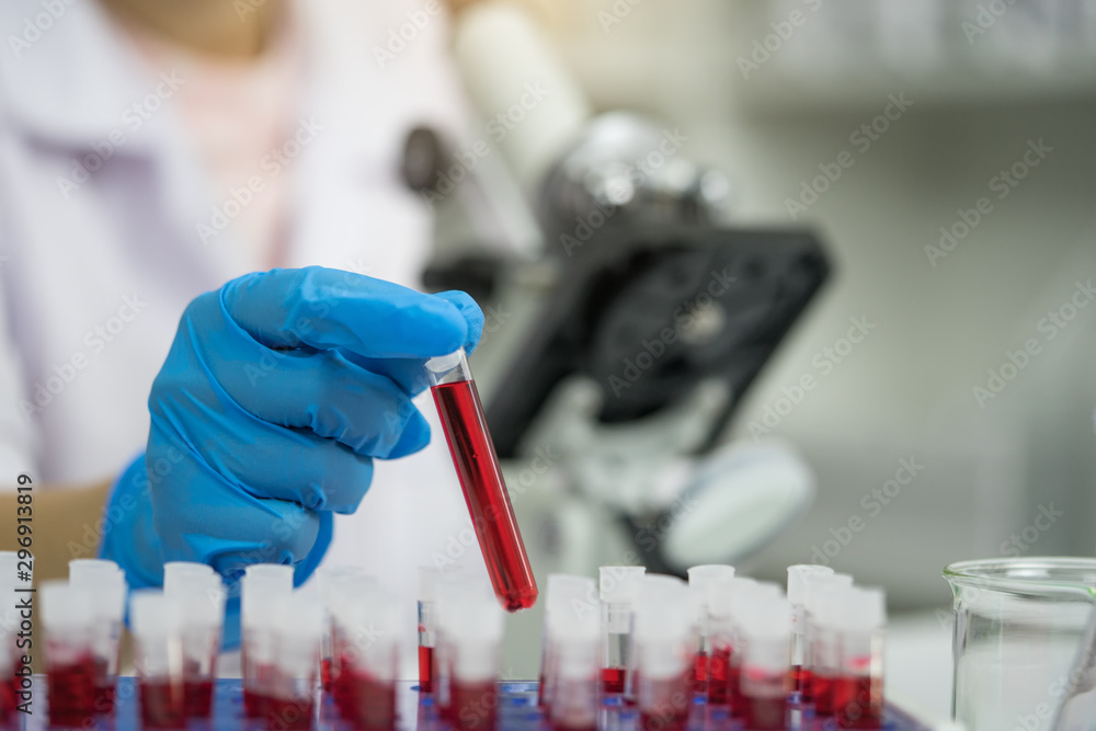 Lab worker putting medical blood sample in place after examining for ...