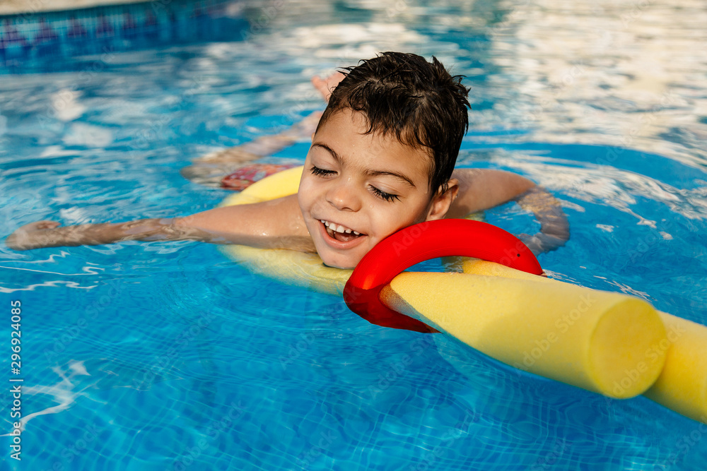 niño jugando y riendo en terapia en piscina con tubo flotador Stock ...