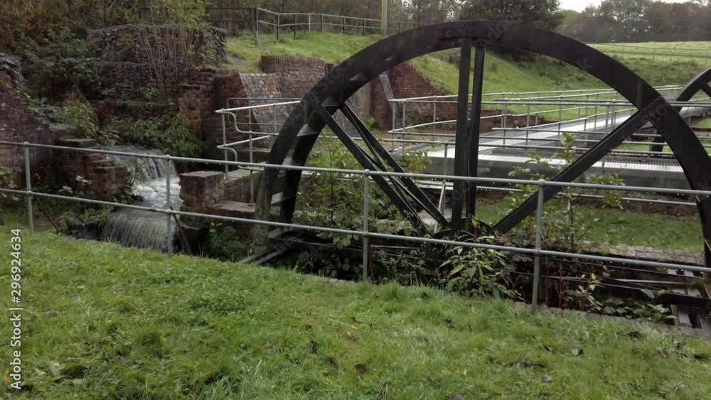 British mining wheel industrial gears in nature reserve canal parkland ...
