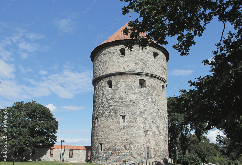 Medieval stone tower and a fragment of the fortress wall. Summer photo ...
