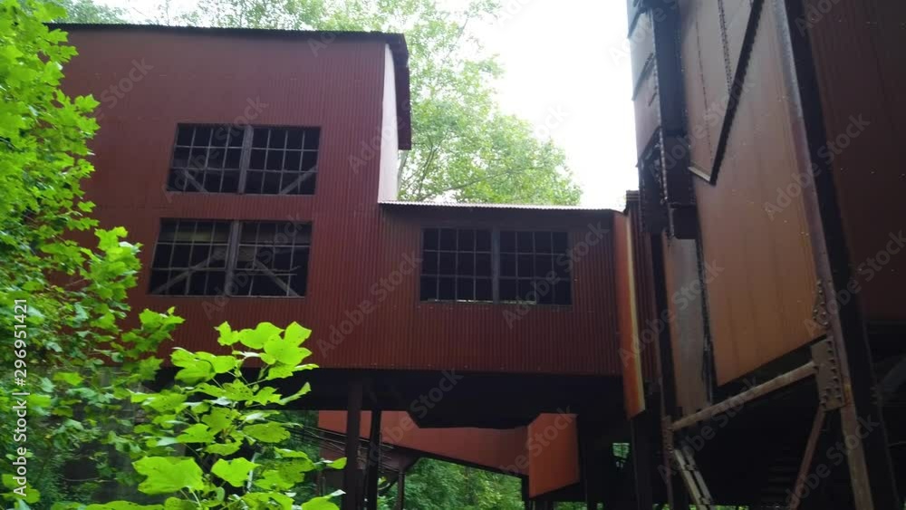 Camera pitching down to reveal the Nuttallburg coal tipple in New River ...