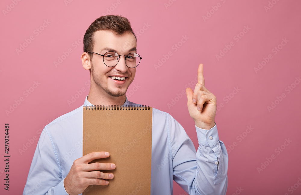 Focus on finger. A young student in a gently blue shirt with glasses ...