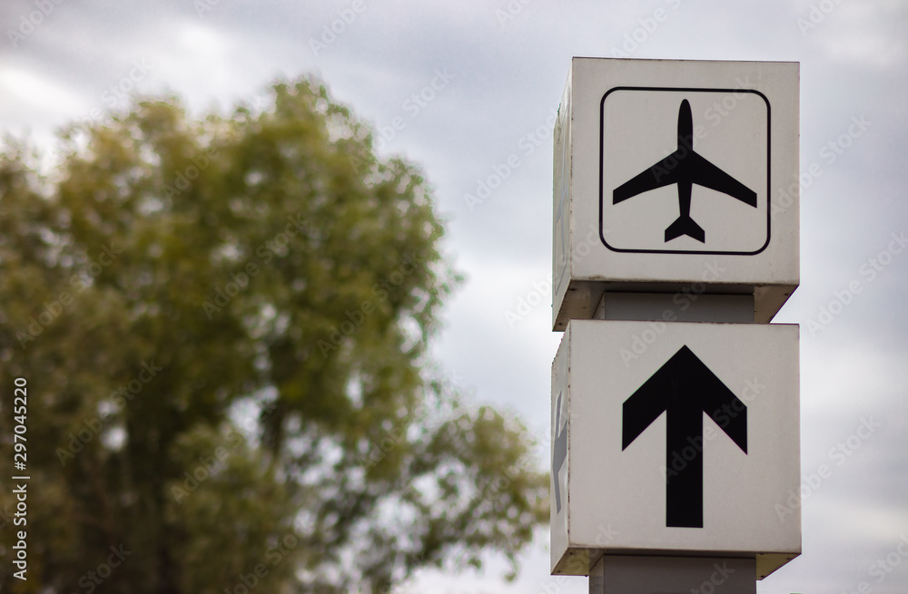 At the airport in Berlin. Two white signs show the way to the airport ...