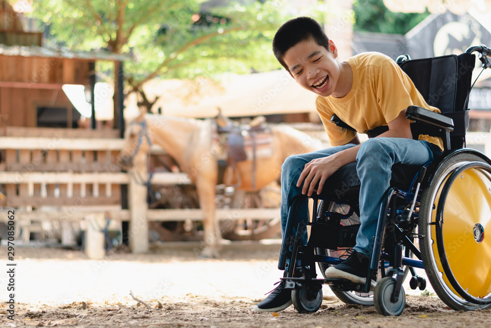 Disabled child on wheelchair is playing, learning and exercise in the ...