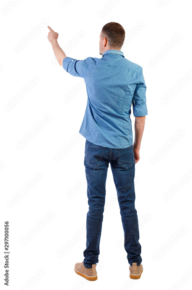 Back view of a man in jeans points his hand upwards. Stock Photo ...