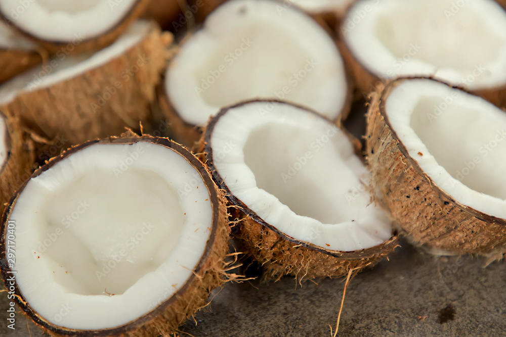 Many coconuts cut in half in organic farm. Lots of fresh flavored ...