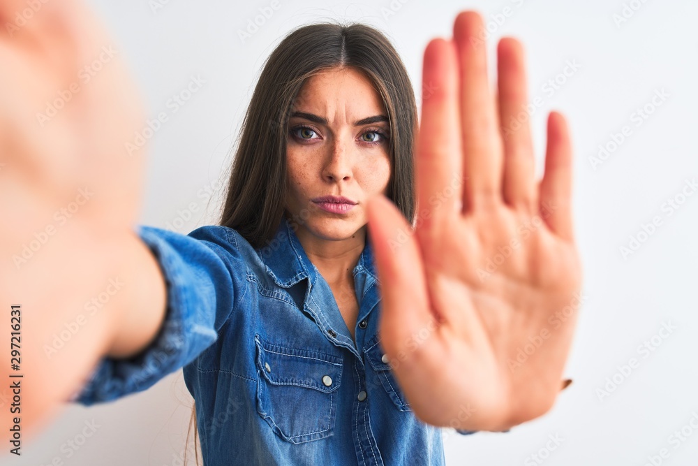 Beautiful woman wearing denim shirt make selfie by camera over isolated ...