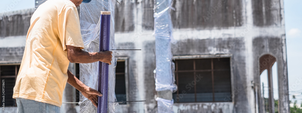 Construction worker is wrapping reinforced concrete piles of the new ...