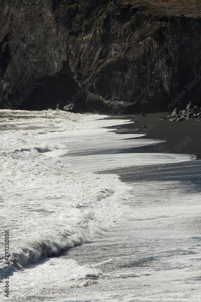 Reynisfjara black basalt sand beach in Vík í Mýrdal in Iceland on the ...