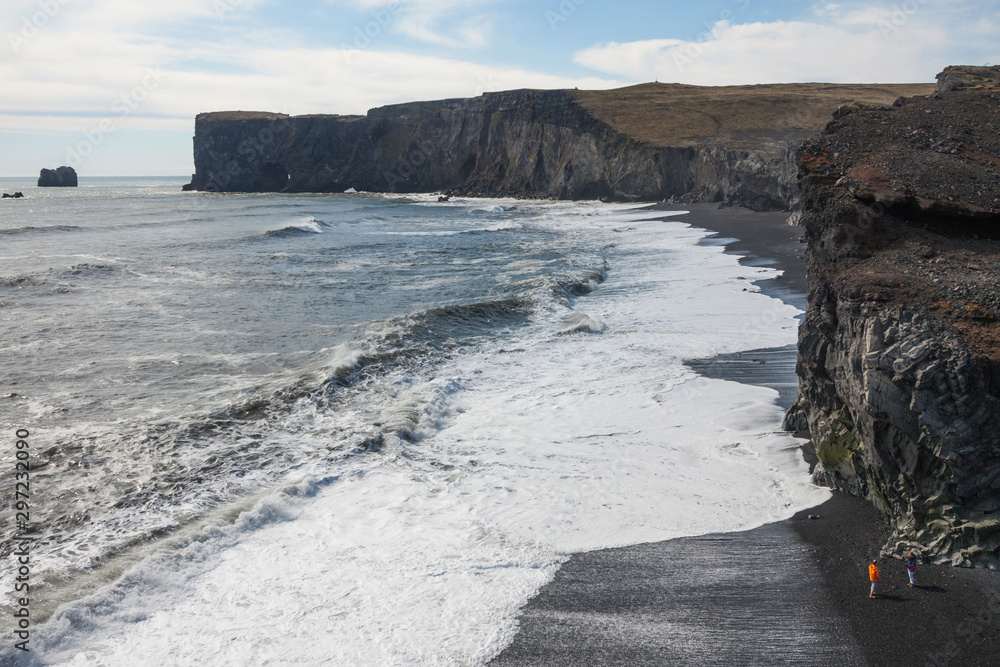 Reynisfjara black basalt sand beach in Vík í Mýrdal in Iceland on the ...
