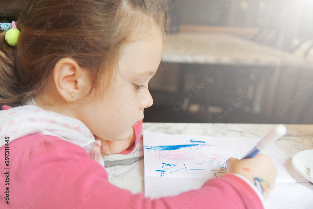 Young little girl painting on a paper note book. Children artistic ...