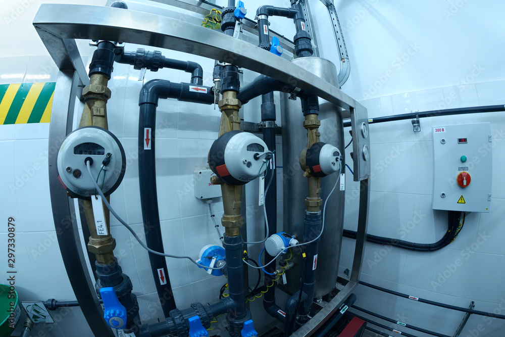 Tubes, manometers set in the dosing systems hall of the water pumping ...