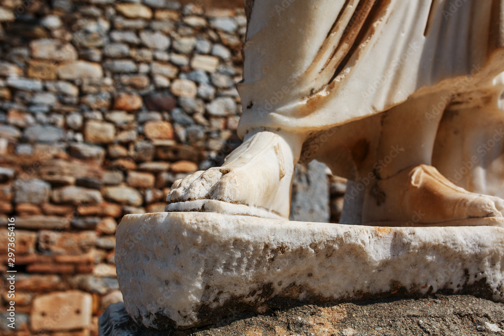 Elements of marble legs of an ancient statue of the ruined city of ...