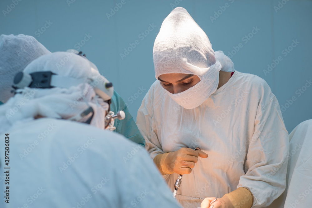 operational team. Girl surgeon looking at the camera during an ...