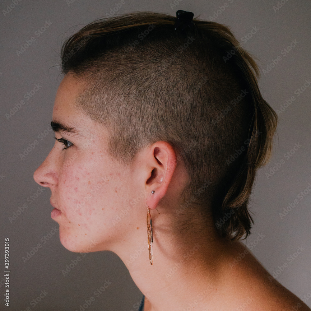Profile of woman with shaved side hairstyle Stock Photo | Adobe Stock