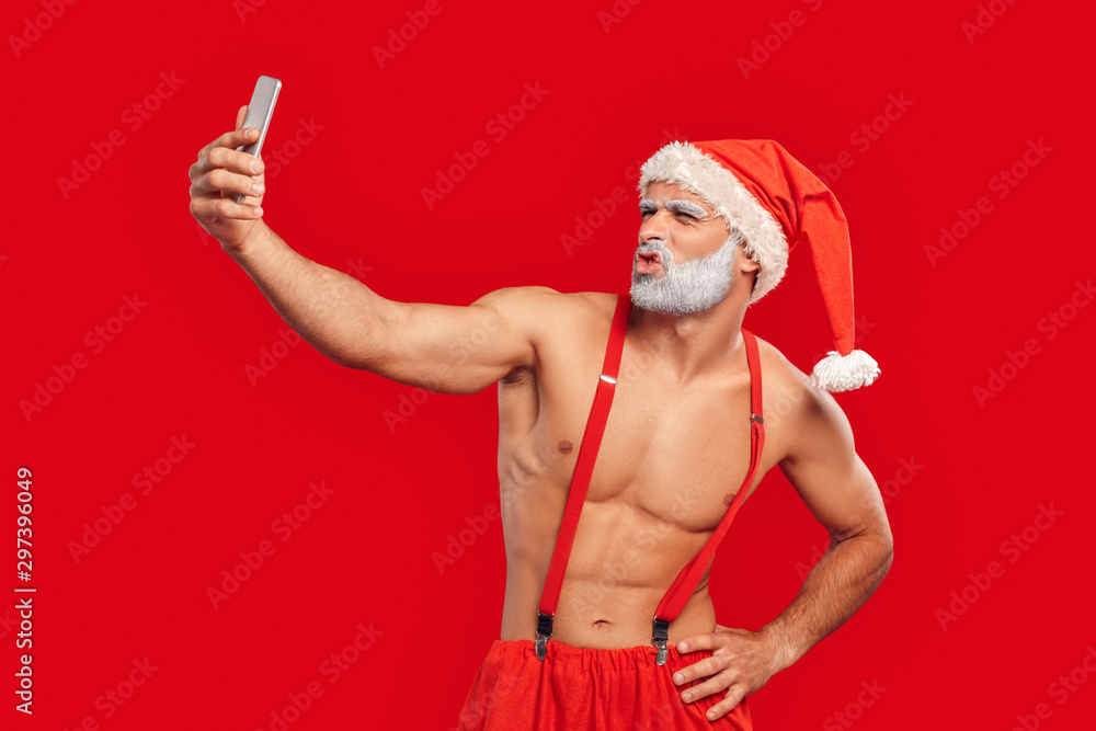 Christmas Freestyle. Young bearded Santa Claus bare muscular upper body ...