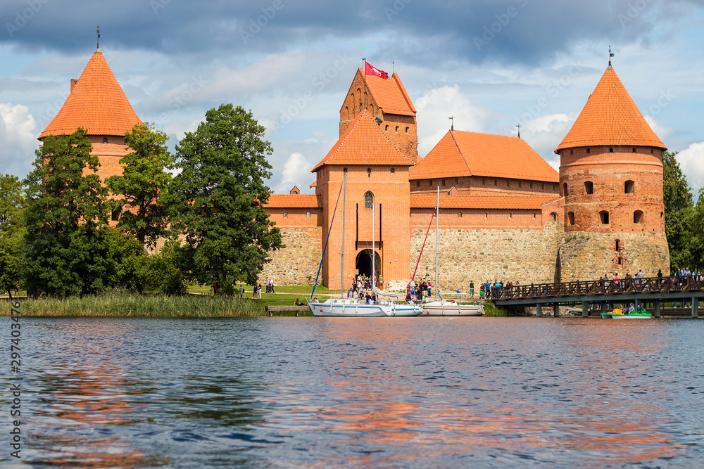 Yachts and medieval gothic Trakai Island Castle with stone walls and ...