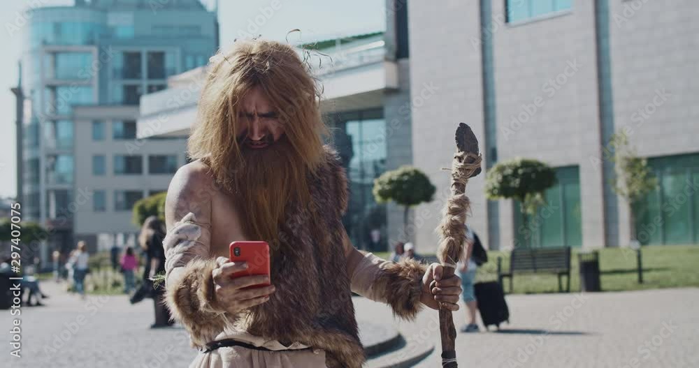 Angry neanderthal of hunter-gatherers discovering modern device use ...