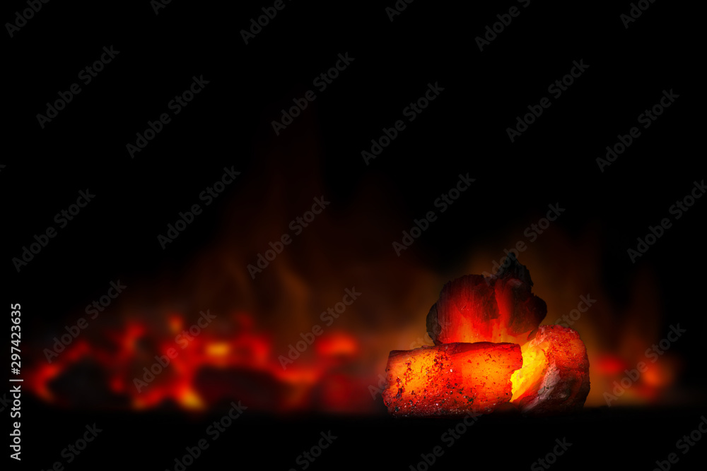 Red hot coal bars in focus on dark background with flames. Background ...