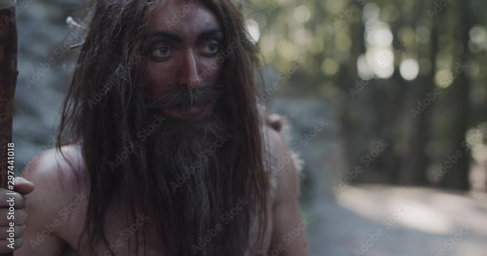 Serious caveman holding weapon neanderthals wearing animal skin stand ...