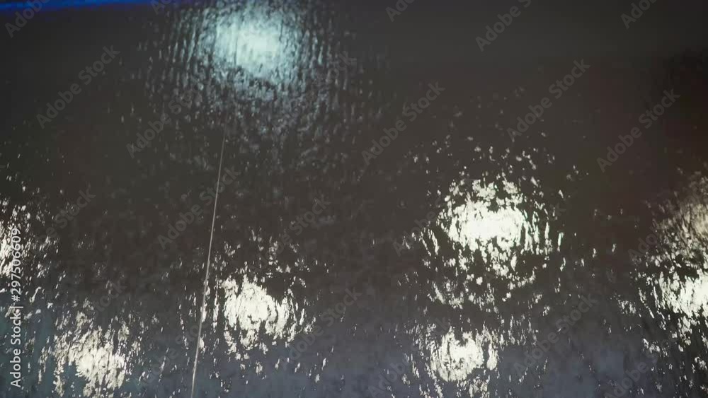 Closeup of decorative waterfall behind frosted glass partition for ...