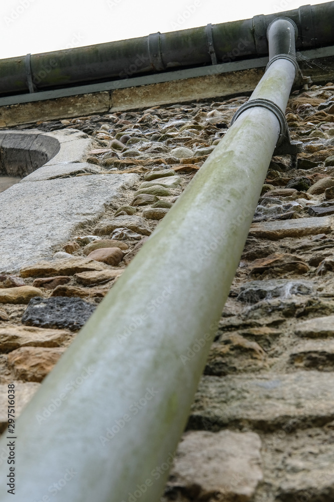 Detailed view of guttering and a rain pipe on a medieval church's ...