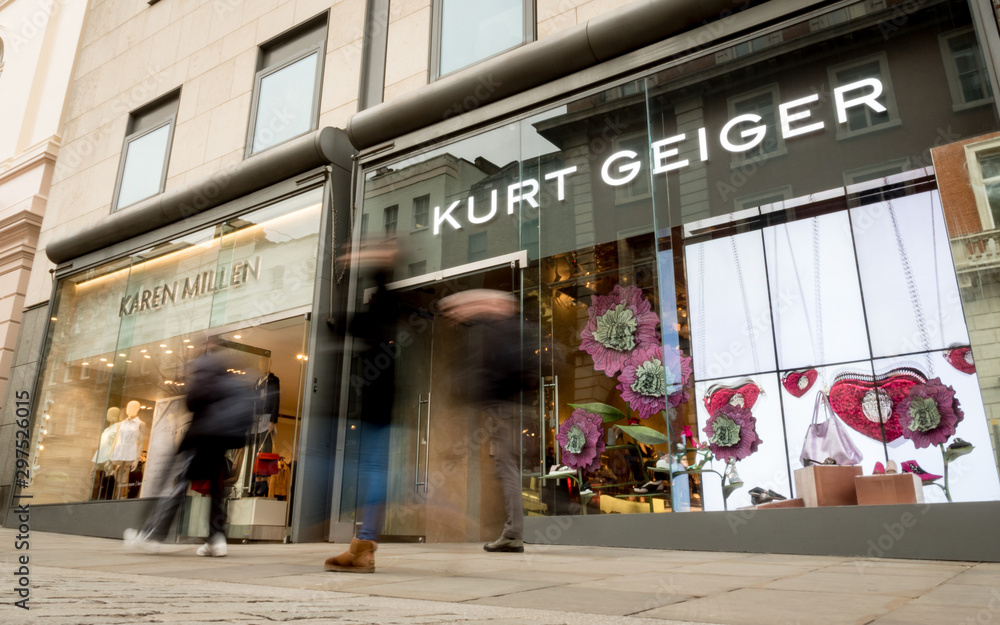 Kurt Geiger store, Covent Garden, London. Blurred shoppers walking by ...
