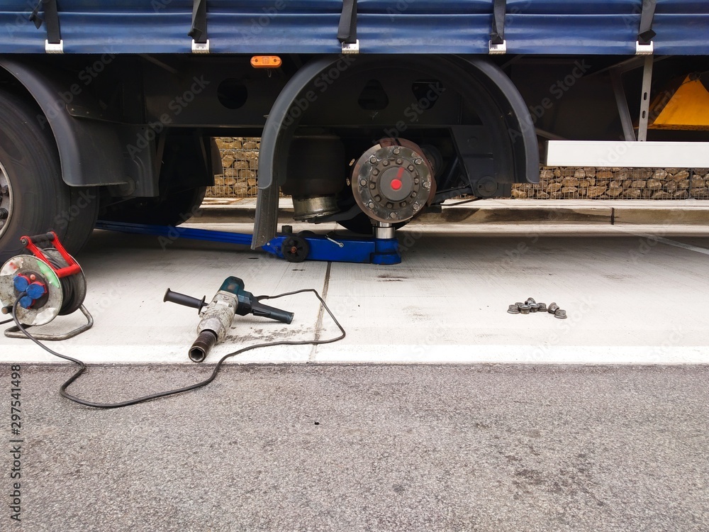 Replacement of a flat tire on a highway truck semitrailer.Removed tire ...