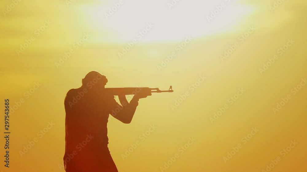 warrior with Kalashnikov at sunset day. fighter is training with a ...