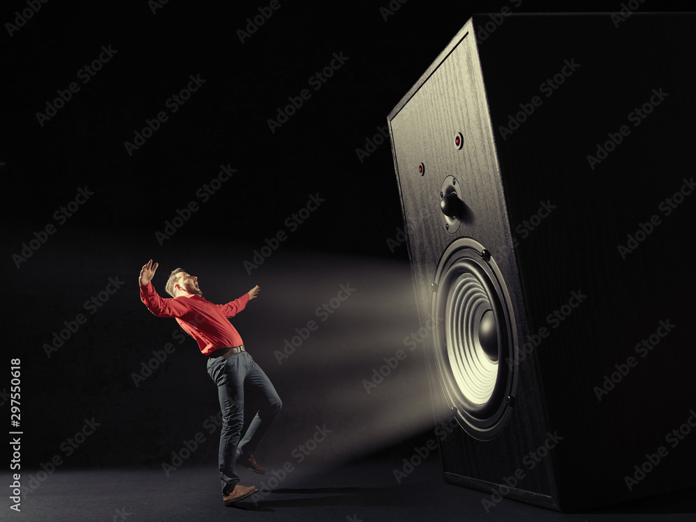 The sound wave from big sound speaker set back a screaming man in red ...