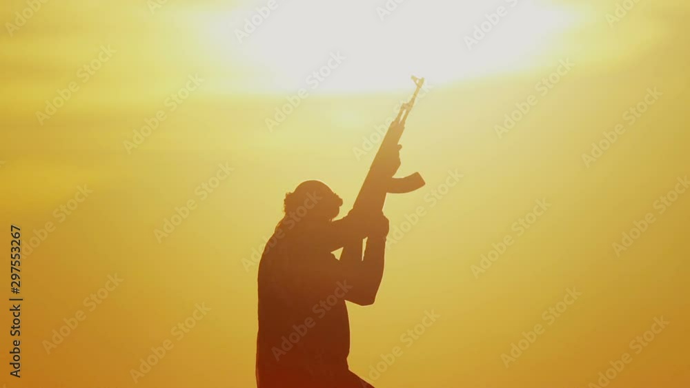 warrior with Kalashnikov at sunset day. fighter is training with a ...