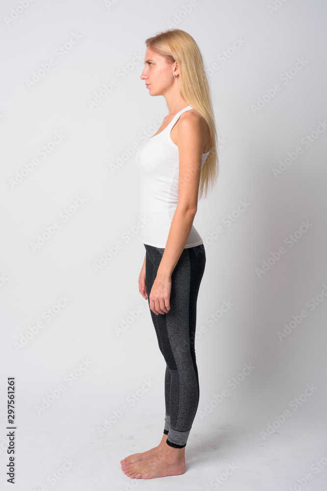 Full body shot profile view of young blonde woman ready for gym Stock ...