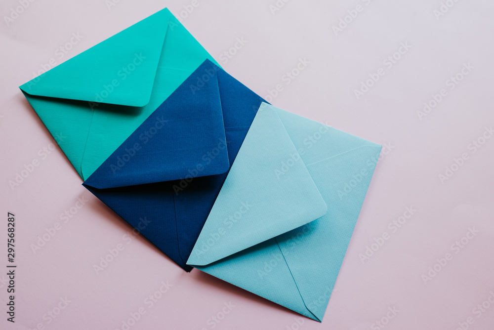 Colored paper envelopes on a light background. New mail, write message ...