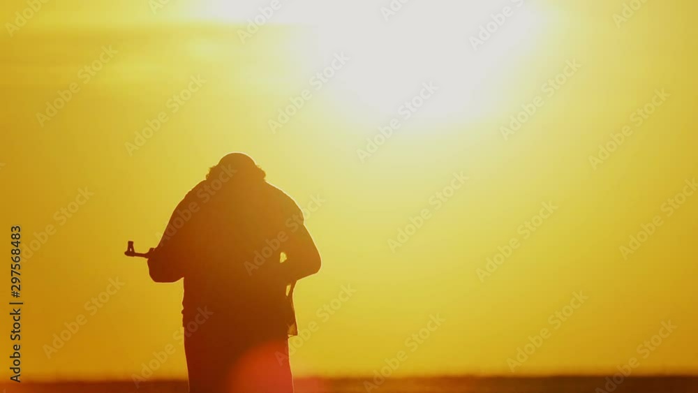 warrior with Kalashnikov at sunset day. fighter is training with a ...