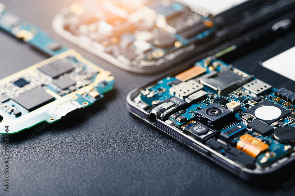 The inside of the smartphone's motherboard and sim card lay on the back ...