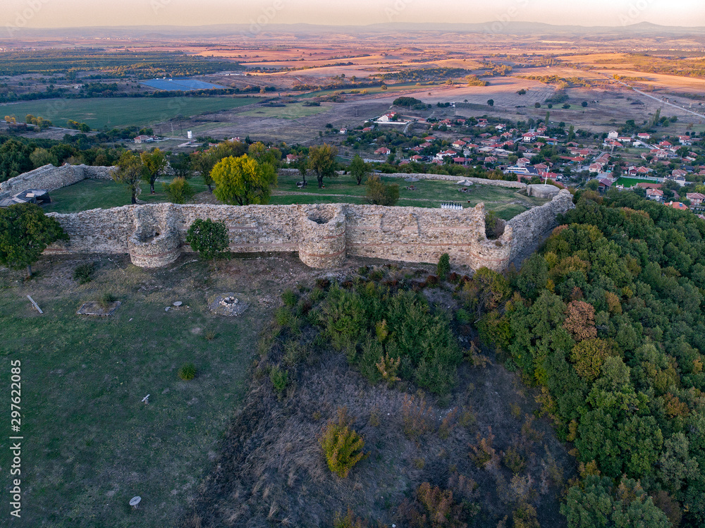 A medieval fortress with preserved walls and watchtowers on top of a ...