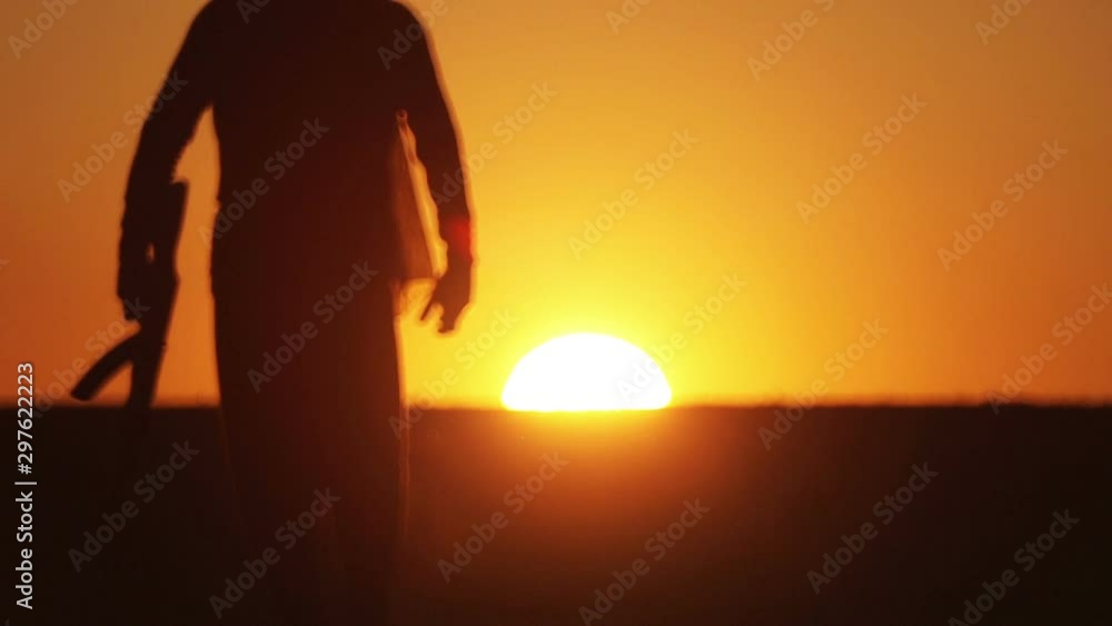 warrior with Kalashnikov at sunset day. fighter is training with a ...
