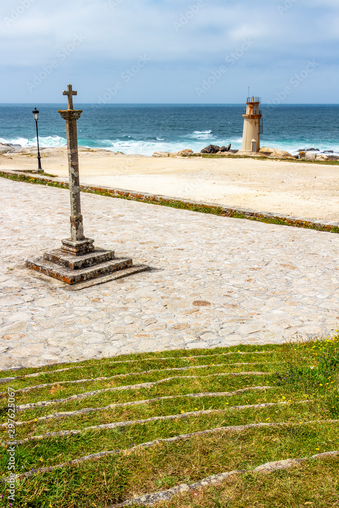 Muxia or Mugia coastal view with ancient cross and the lighthouse, Faro ...