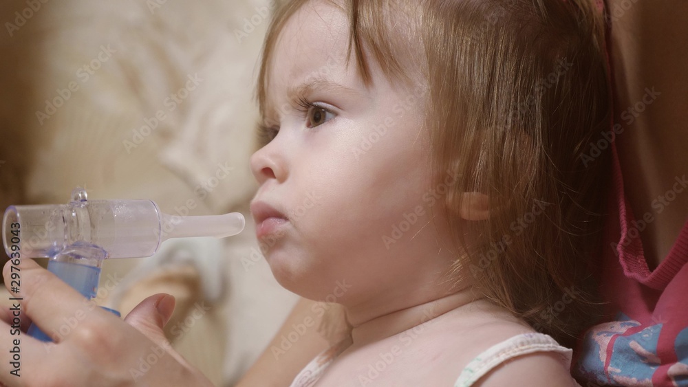 little girl treated with an inhalation mask on her face in hospital ...