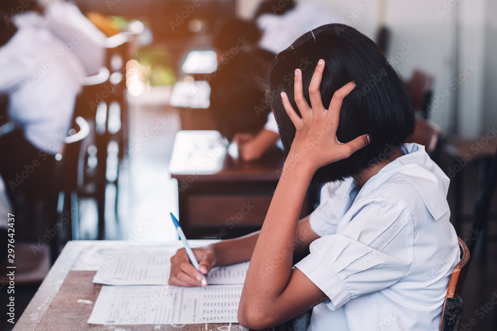 Students taking exam with stress in school classroom Stock Photo ...