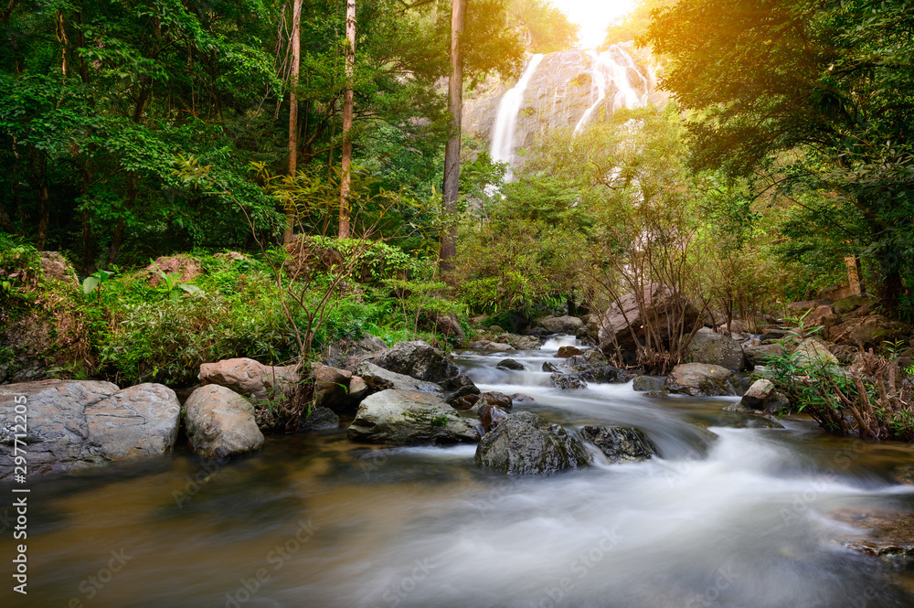 A beautiful waterfall deep in the tropical forest, steep mountain ...