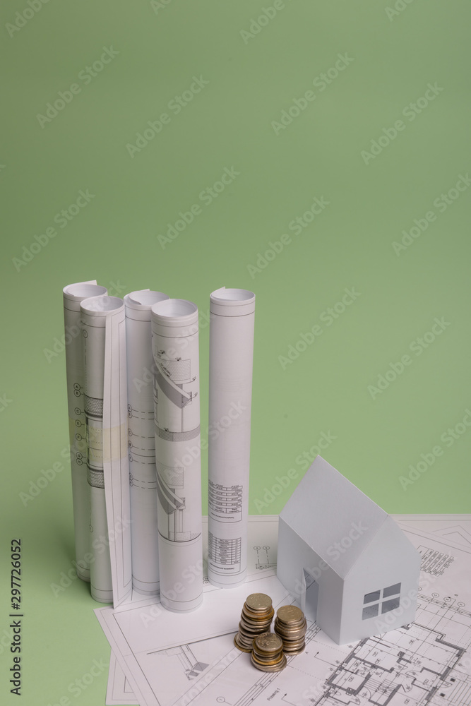 White family paper house , stack of money coins, house projects plan ...