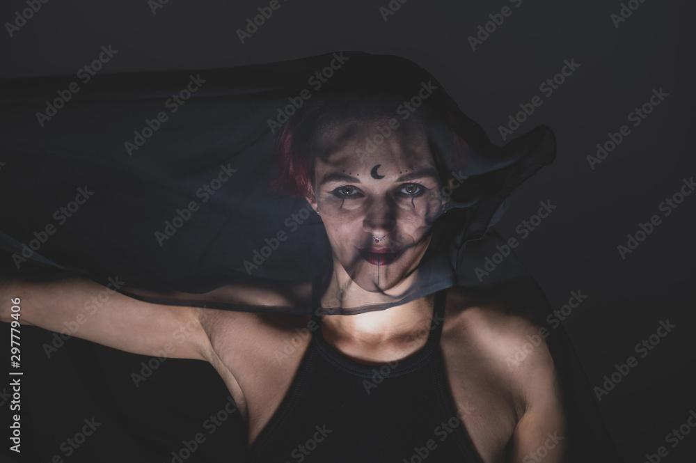 Woman in a black veil with dark makeup and an earring in her nose ...