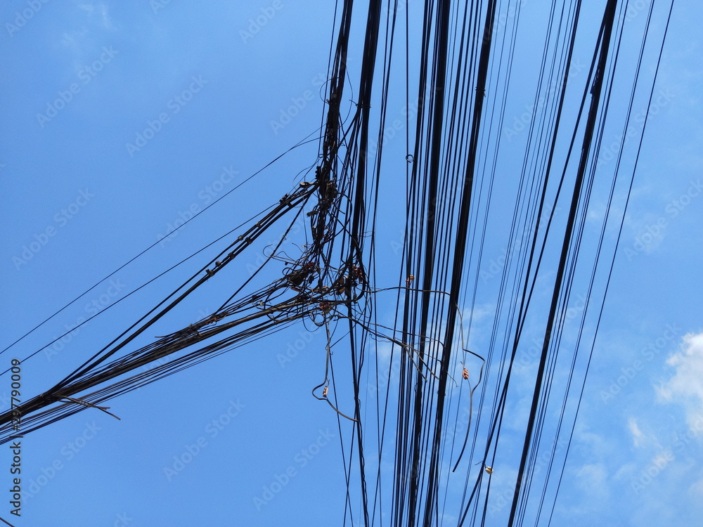 ant's eye view of electric cable hang on tower with blue sky background ...