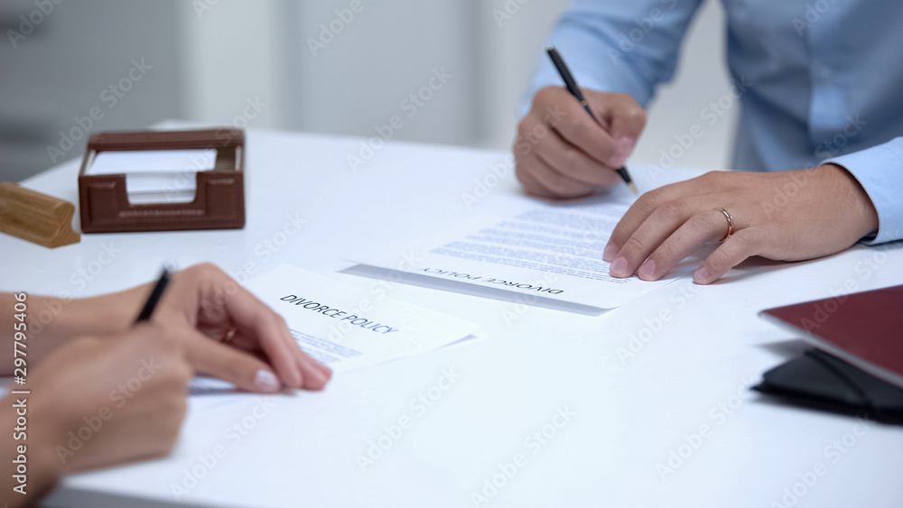 Couple signing divorce policy in attorney office, legal end of ...