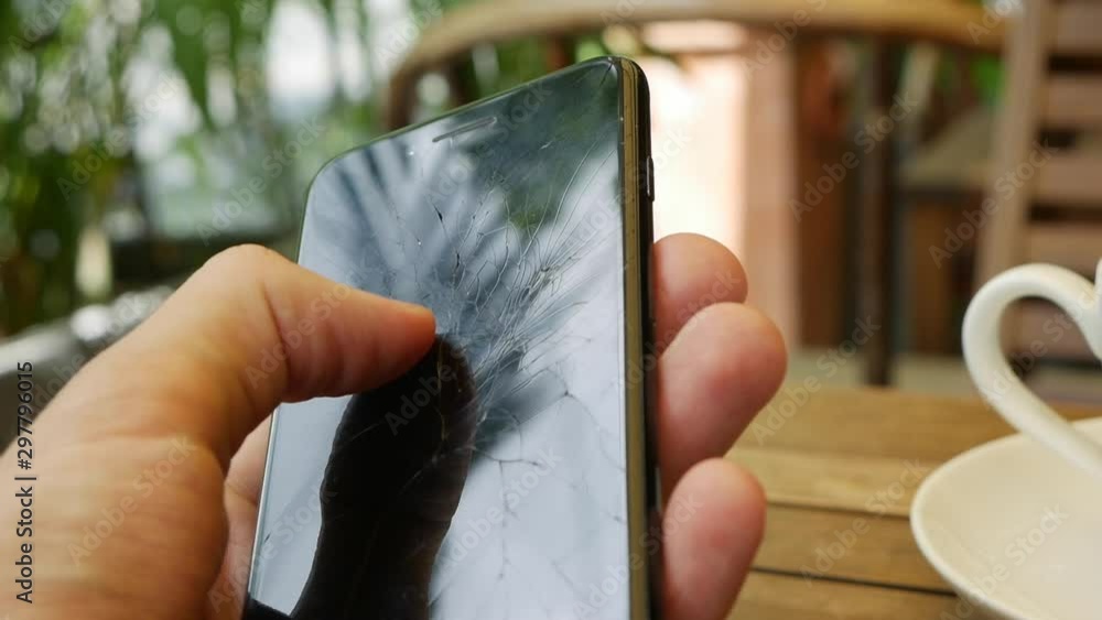 Concept of smart phone with broken screen. Top view of man hands ...