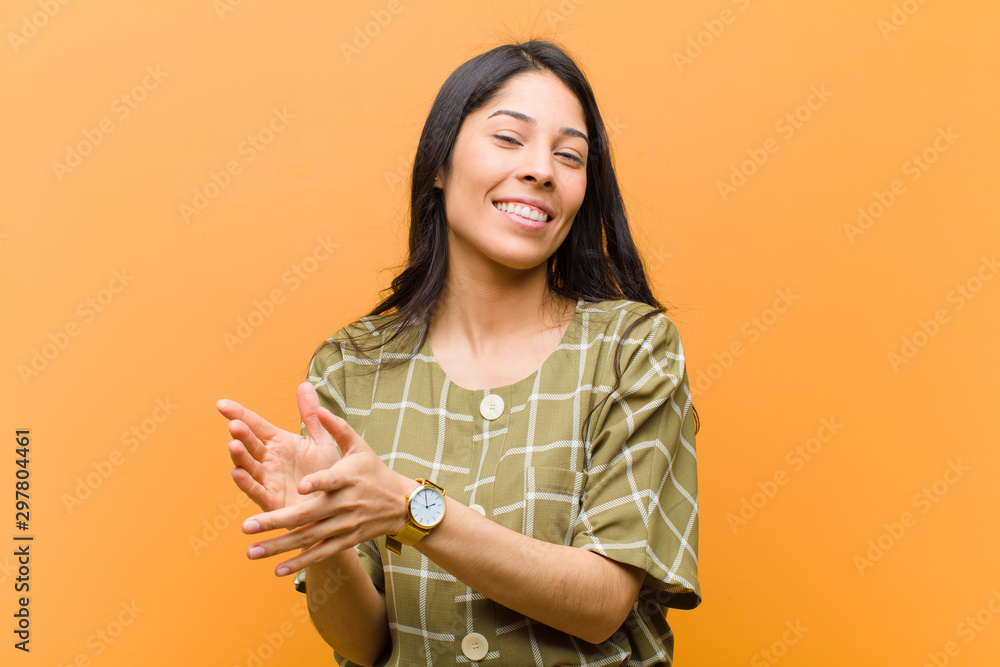 young pretty hispanic woman feeling happy and successful, smiling and ...