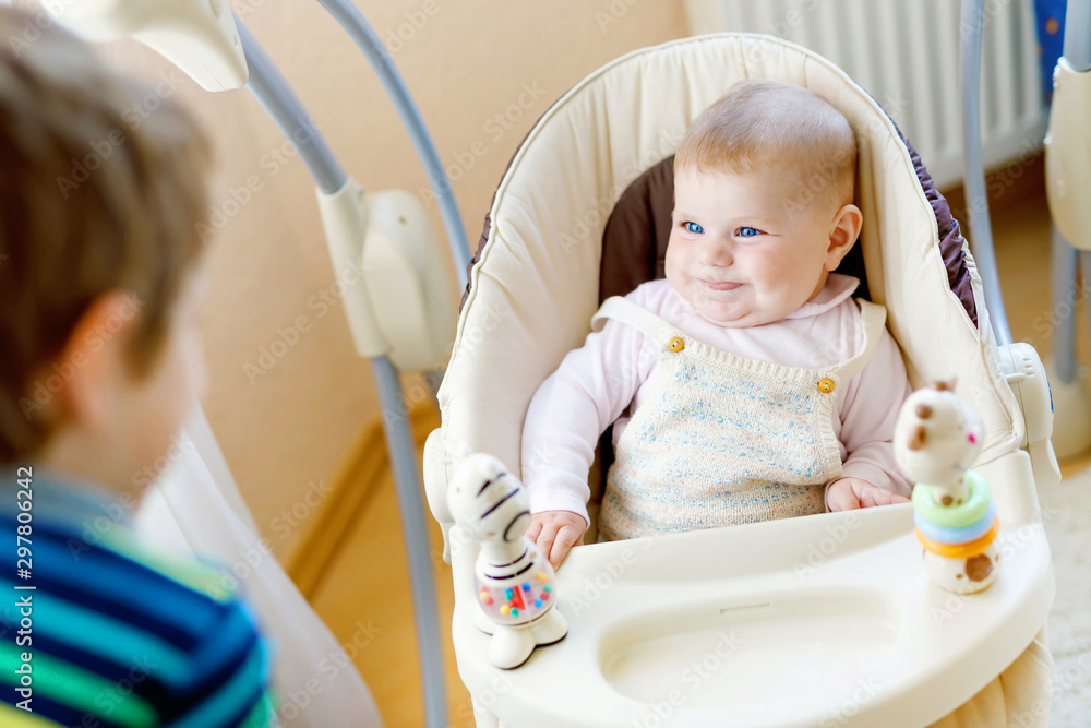 Happy little kid boy with newborn baby girl, cute sister. Siblings ...