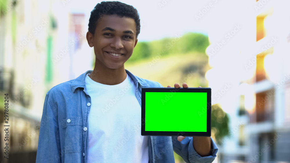 Young Afro-American boy showing green screen tablet, online education ...